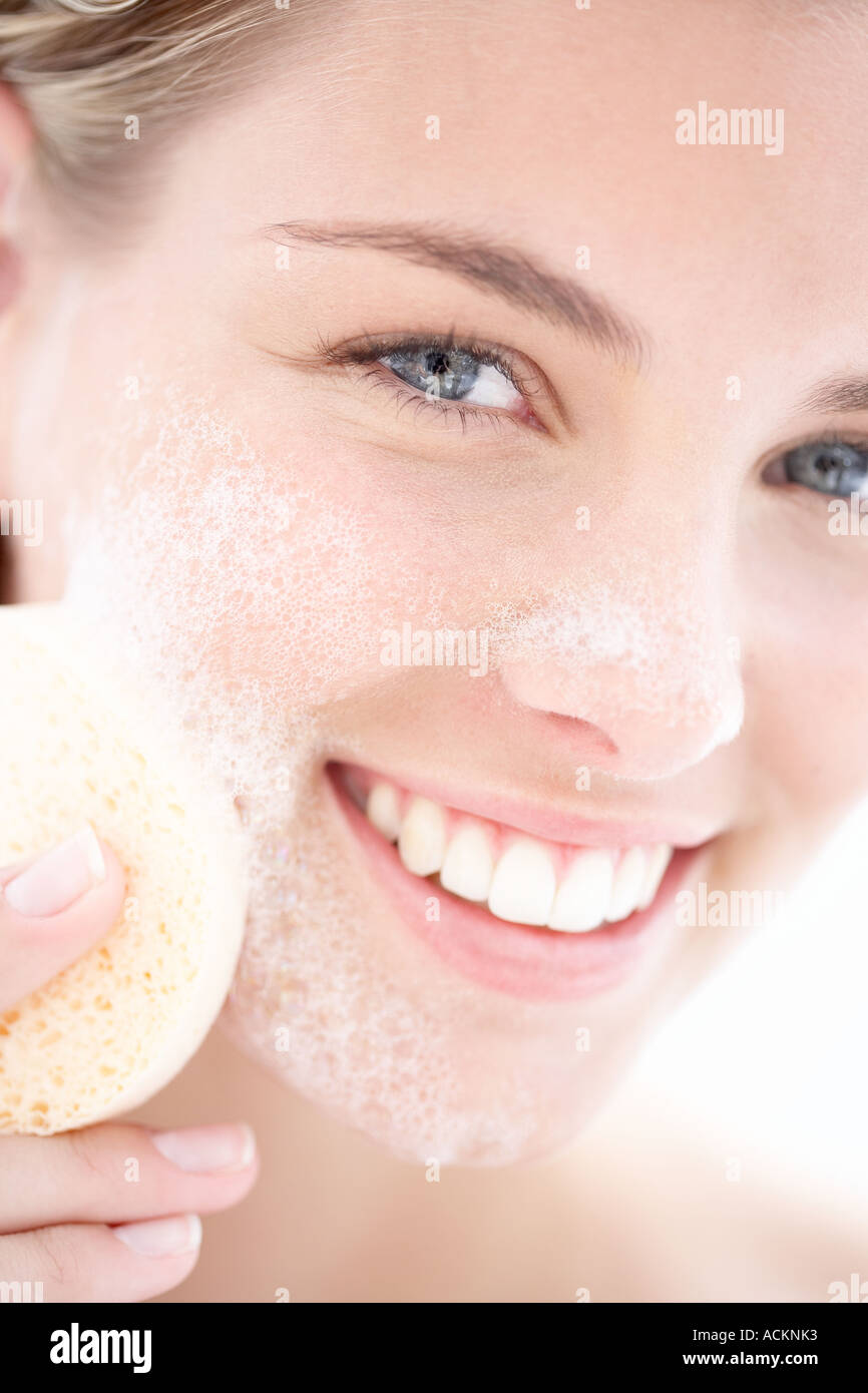 A young woman washing her face with a pad Stock Photo - Alamy