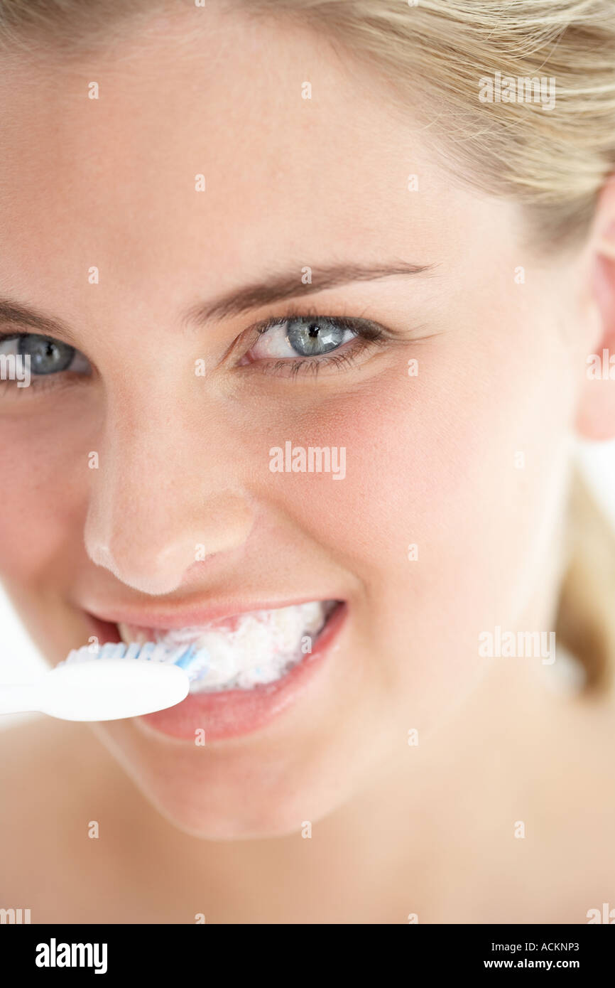 A young woman brushing her teeth close up Stock Photo - Alamy