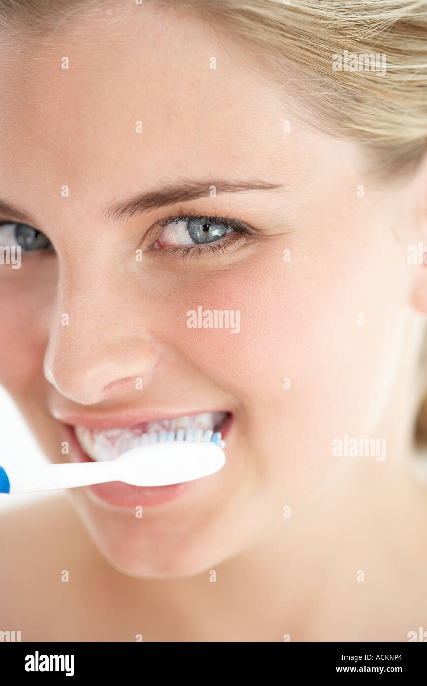A young woman brushing her teeth close up Stock Photo - Alamy