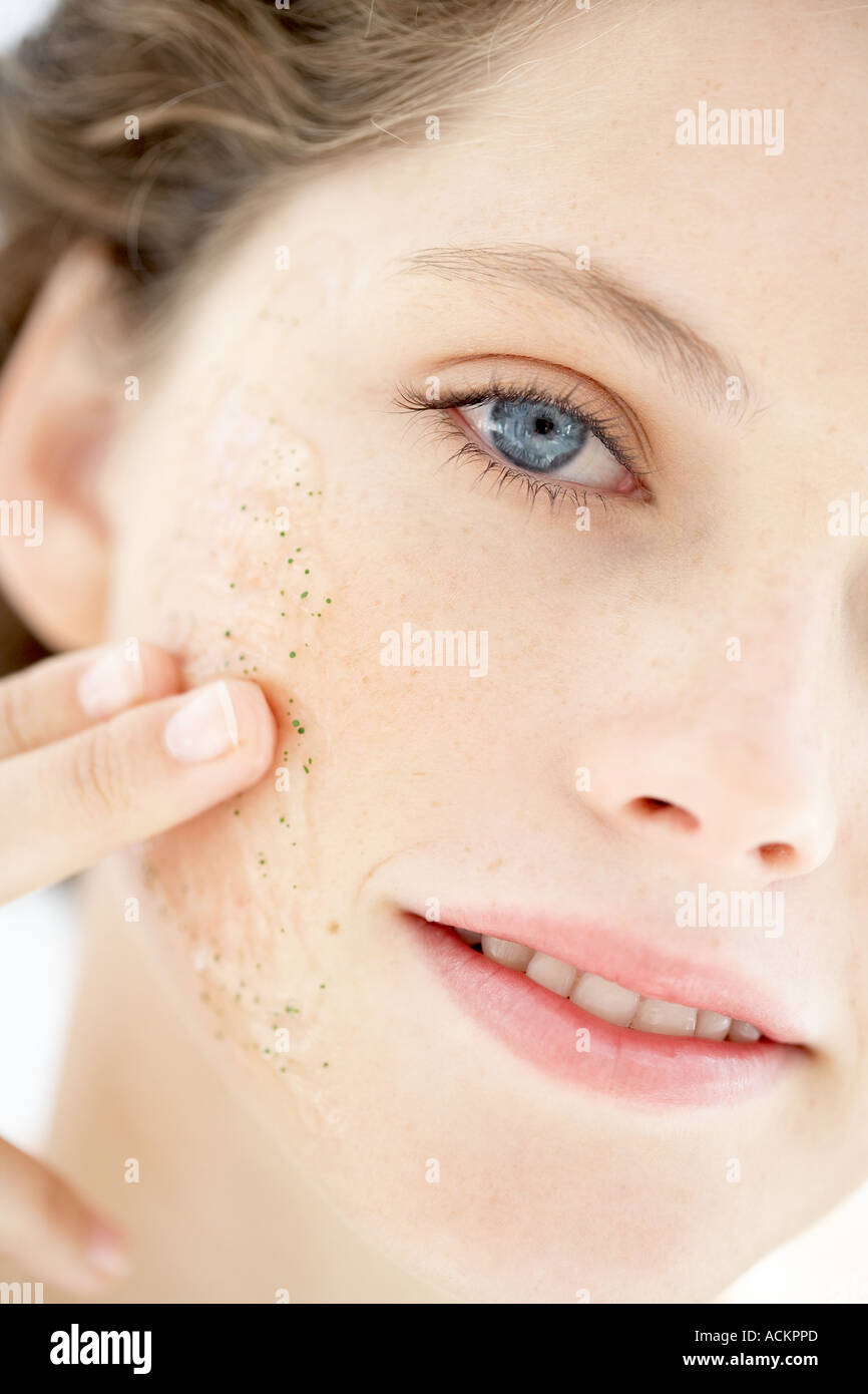 Young woman applying gel on face Stock Photo - Alamy