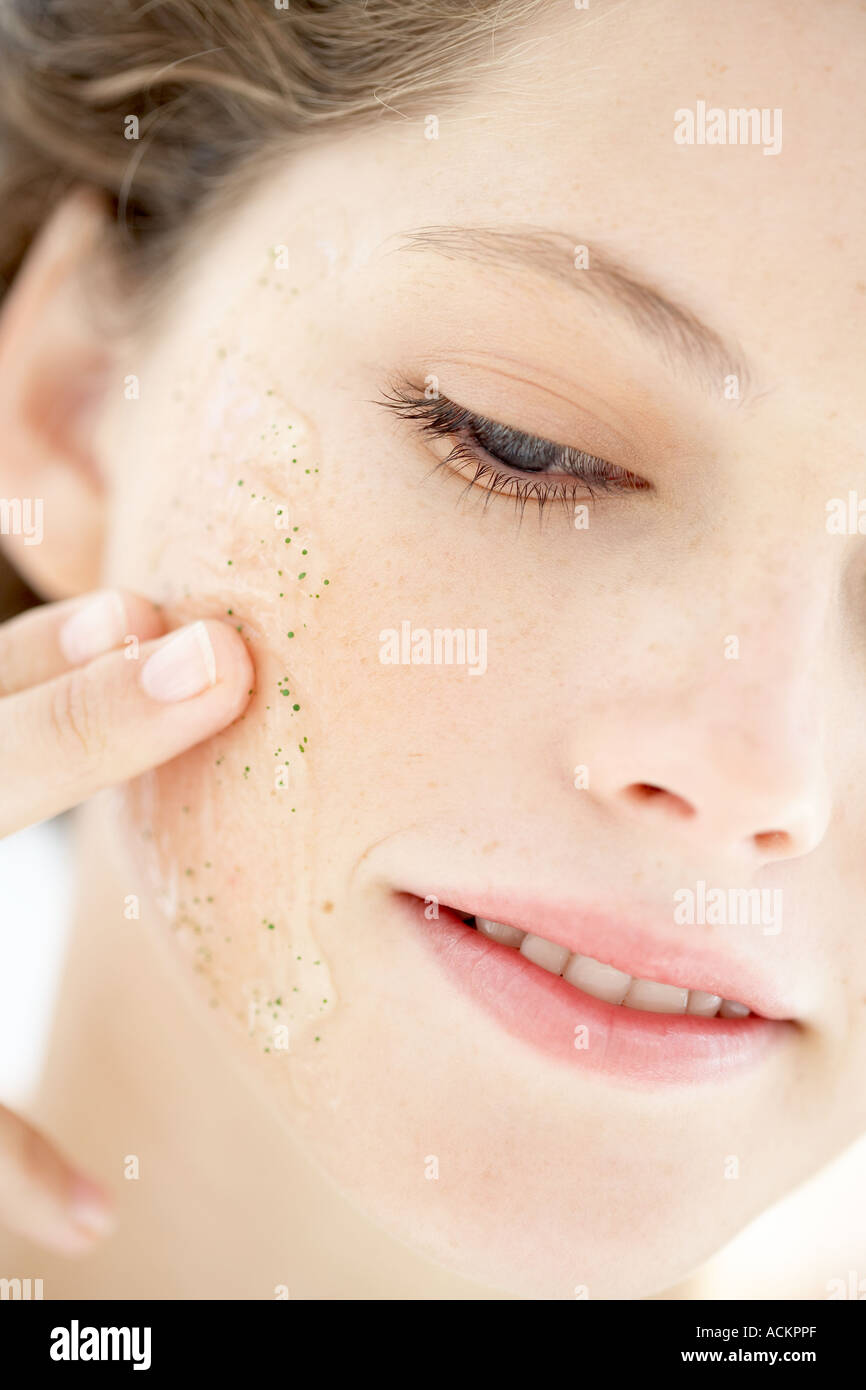 Young woman applying gel on face Stock Photo - Alamy