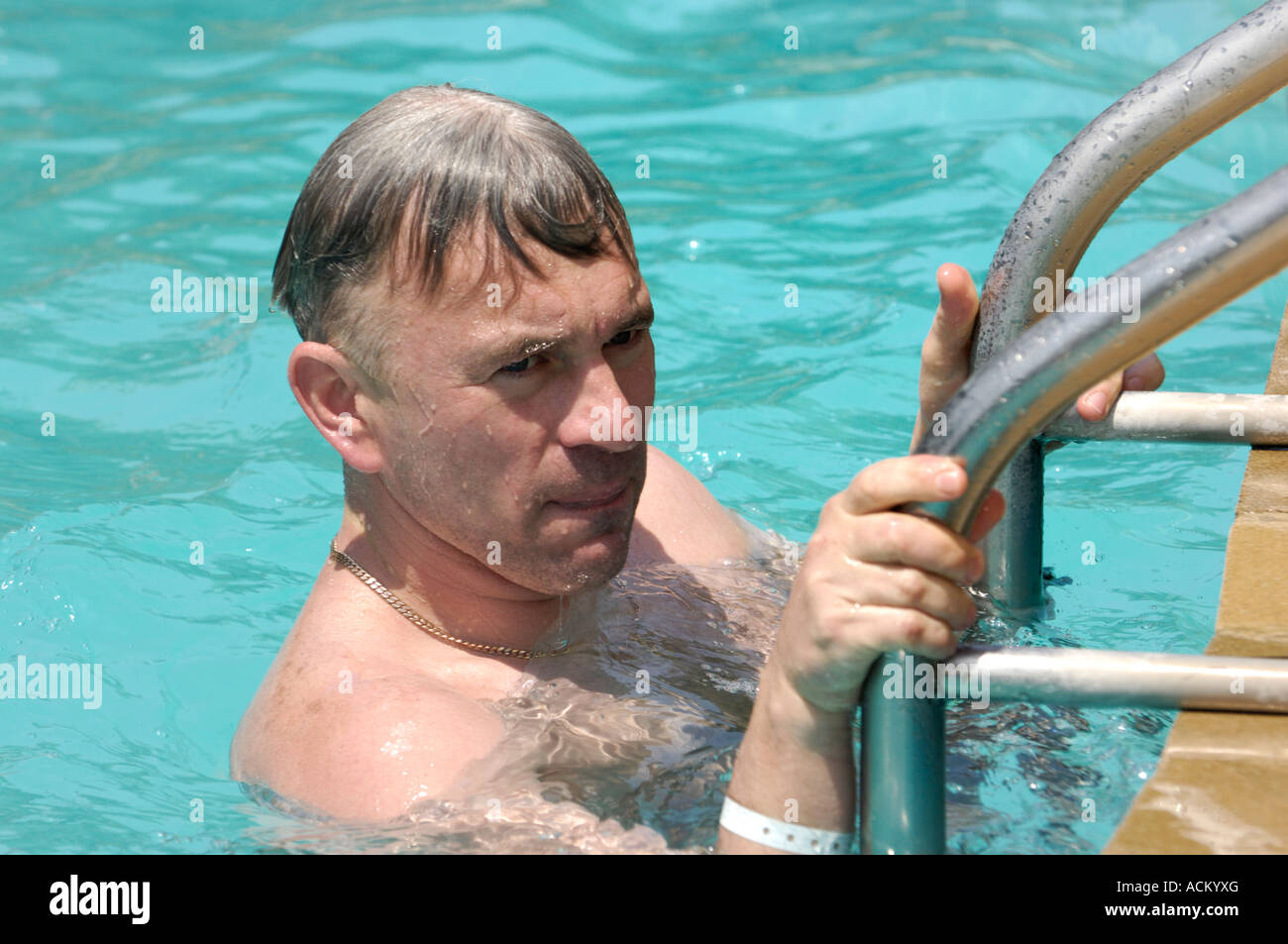 Adult man getting out of a swimming pool Stock Photo - Alamy