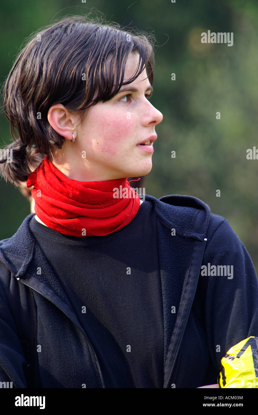 Pretty young girl brunette with red scarf around her neck standing ...
