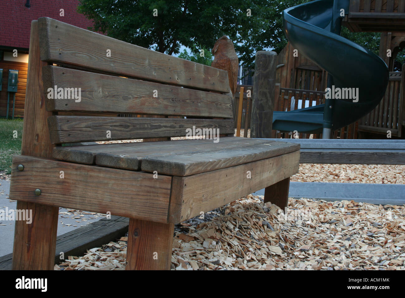 Park bench at children's playground Stock Photo - Alamy