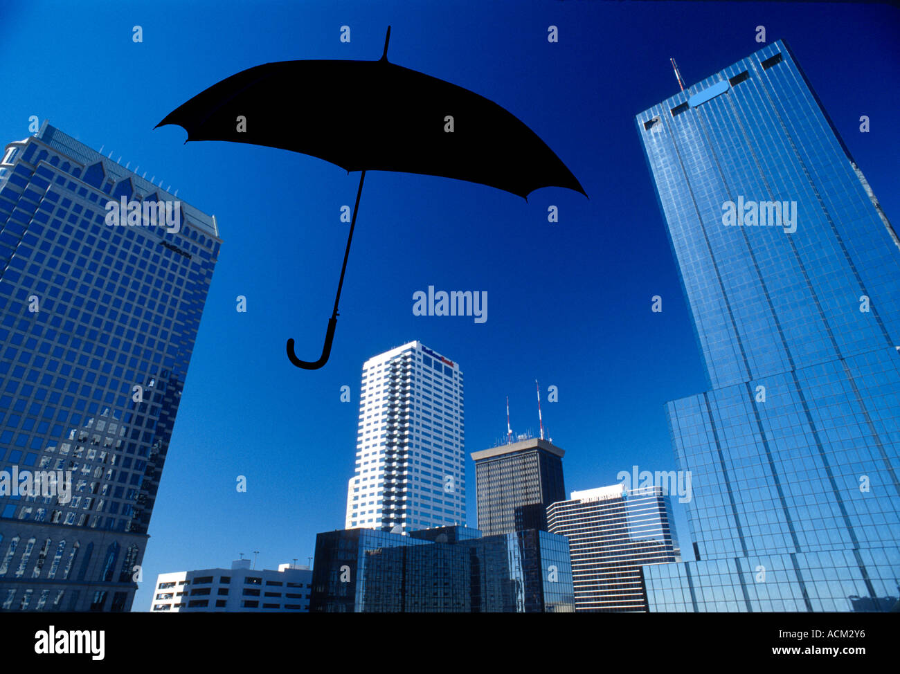 conceptual view of black umbrella floating among tall skyscraper ...