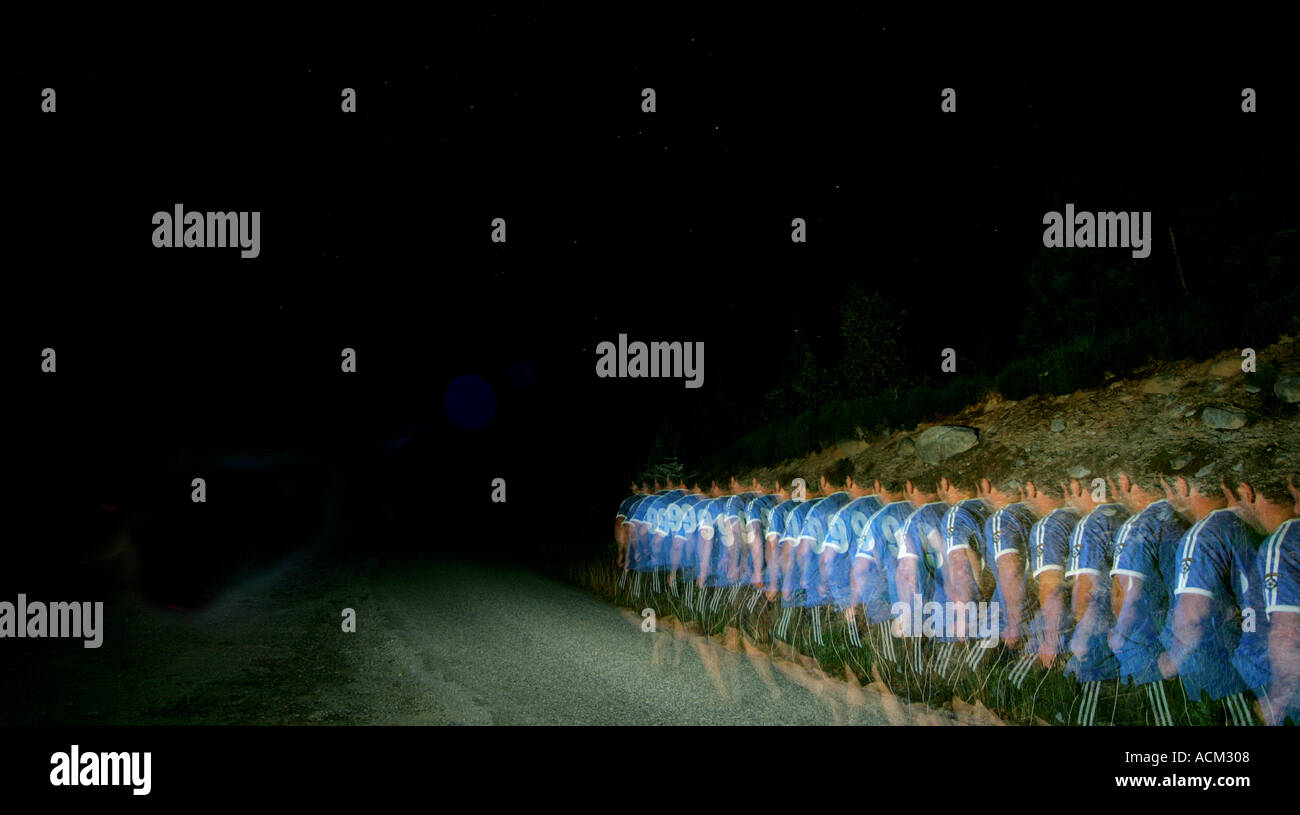 Man walking on a road at night Stock Photo - Alamy