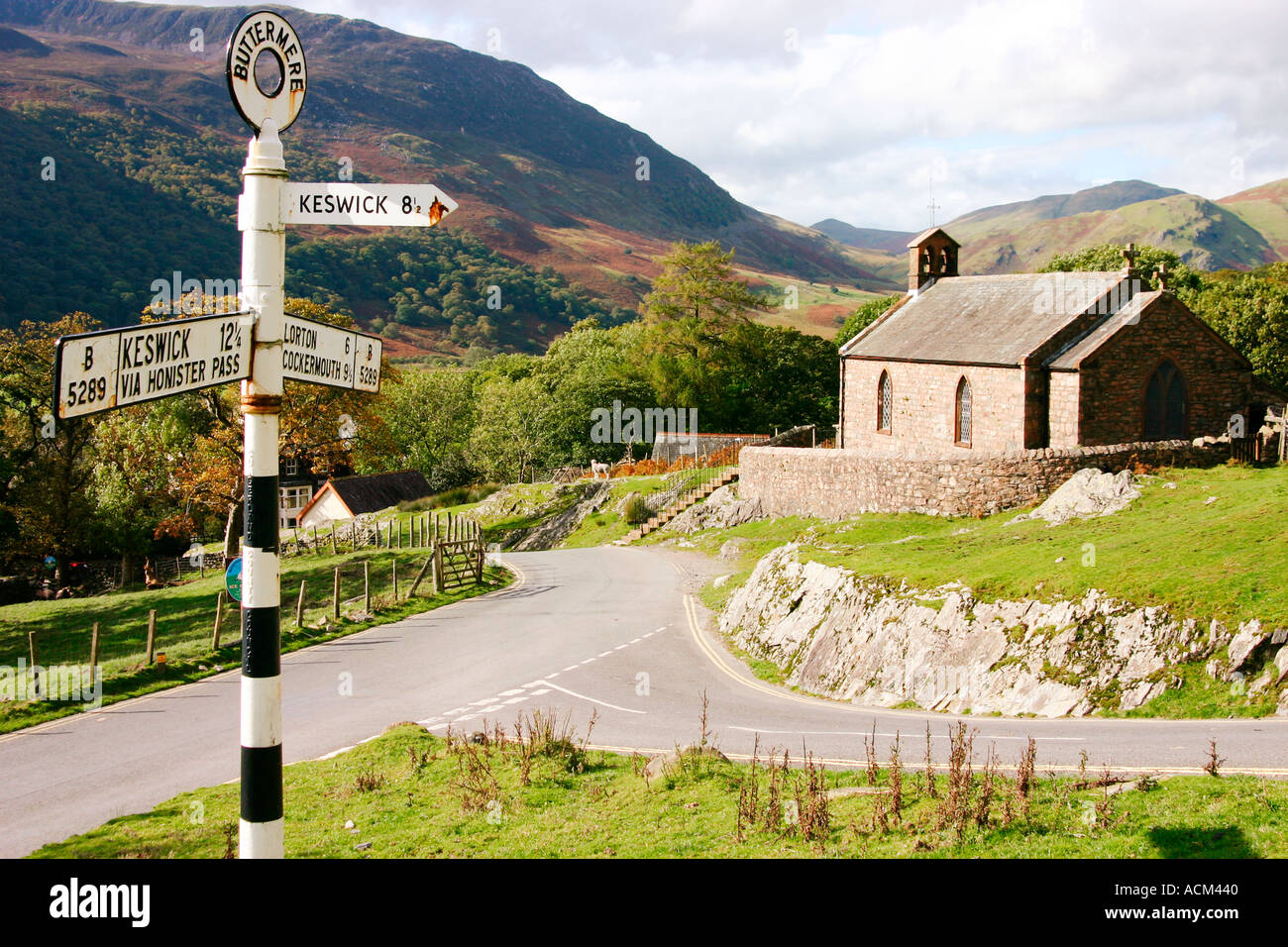 junction road sign and St james Church Buttermere lake District England ...