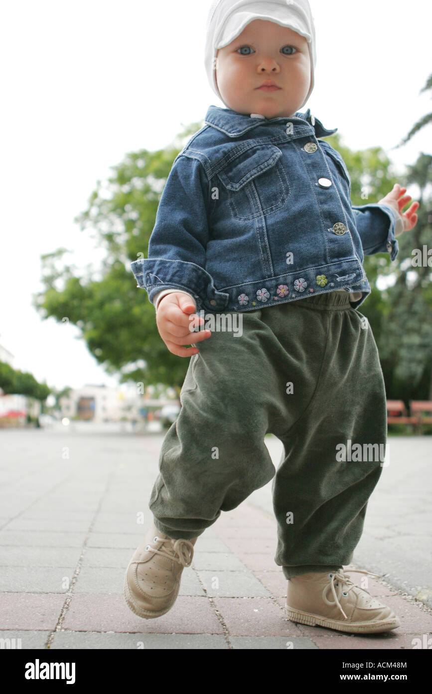 A little boy is learning to walk outdoor Stock Photo - Alamy
