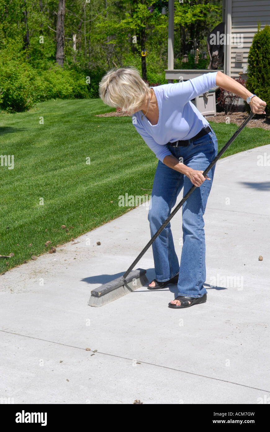 Sweeping and cleaning after doing yard work Stock Photo - Alamy