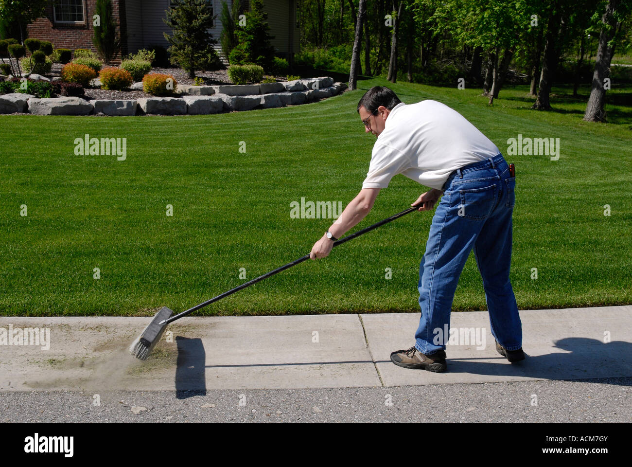 Sweeping and cleaning after doing yard work Stock Photo - Alamy