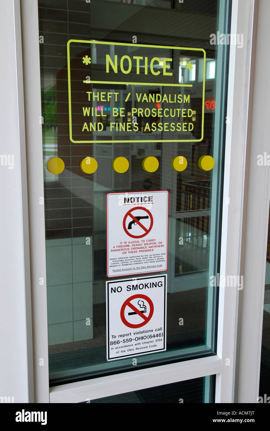 Signs on door prohibiting firearms guns weapons no smoking Stock Photo ...