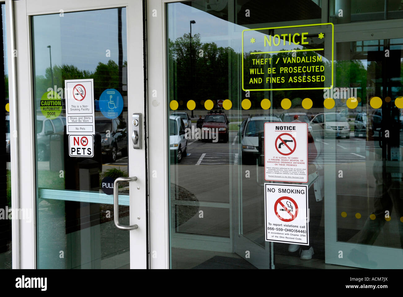 Signs on door prohibiting firearms guns weapons no smoking Stock Photo ...