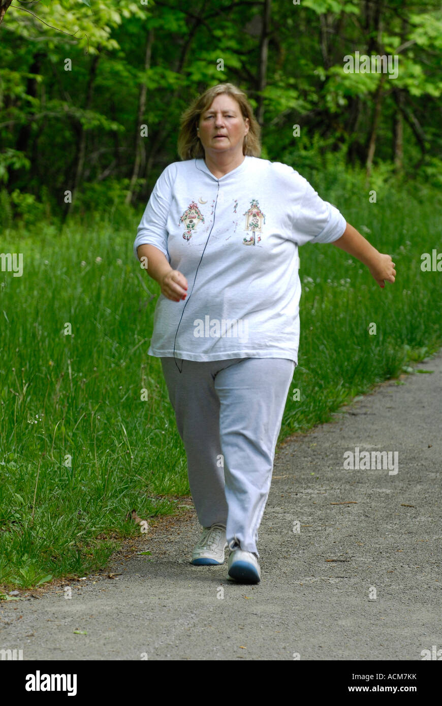 Overweight woman walking for exercise in Ohiopyle State Park Recreation ...