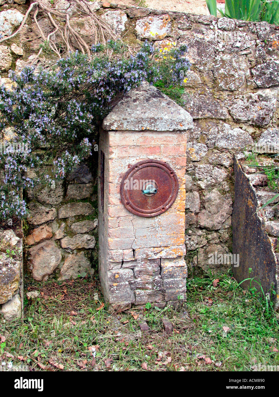 old sampling point for water by an old mural Tuscany Stock Photo - Alamy
