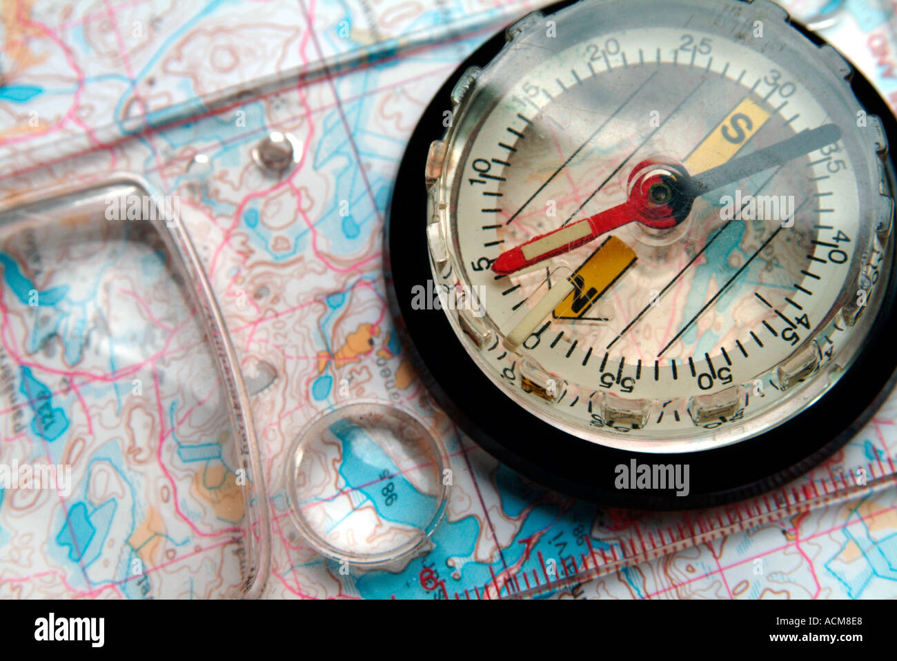 orientation with a map and a compass Stock Photo - Alamy