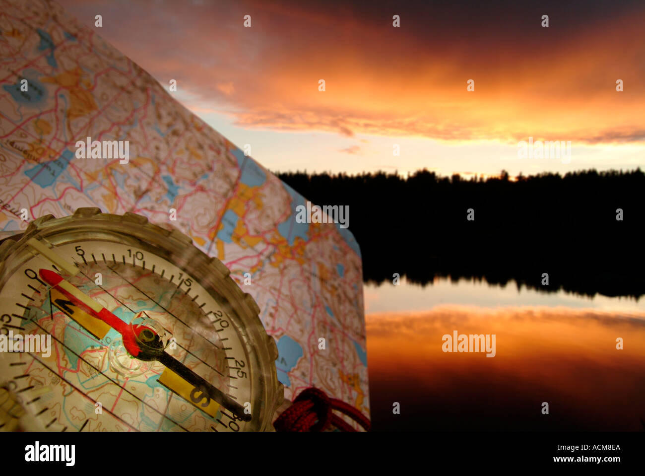 orientation in the nature with a map and a compass Stock Photo - Alamy