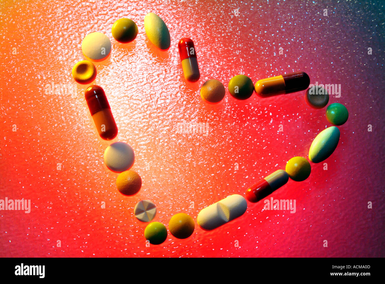 heart made of many different colourful pills and capsules on fire red ...
