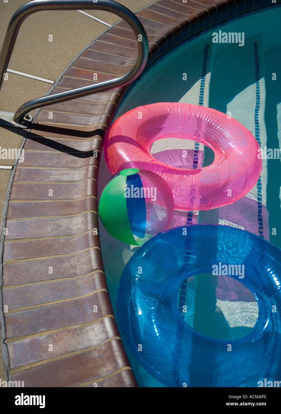 Inflatable toys in a backyard pool Stock Photo - Alamy