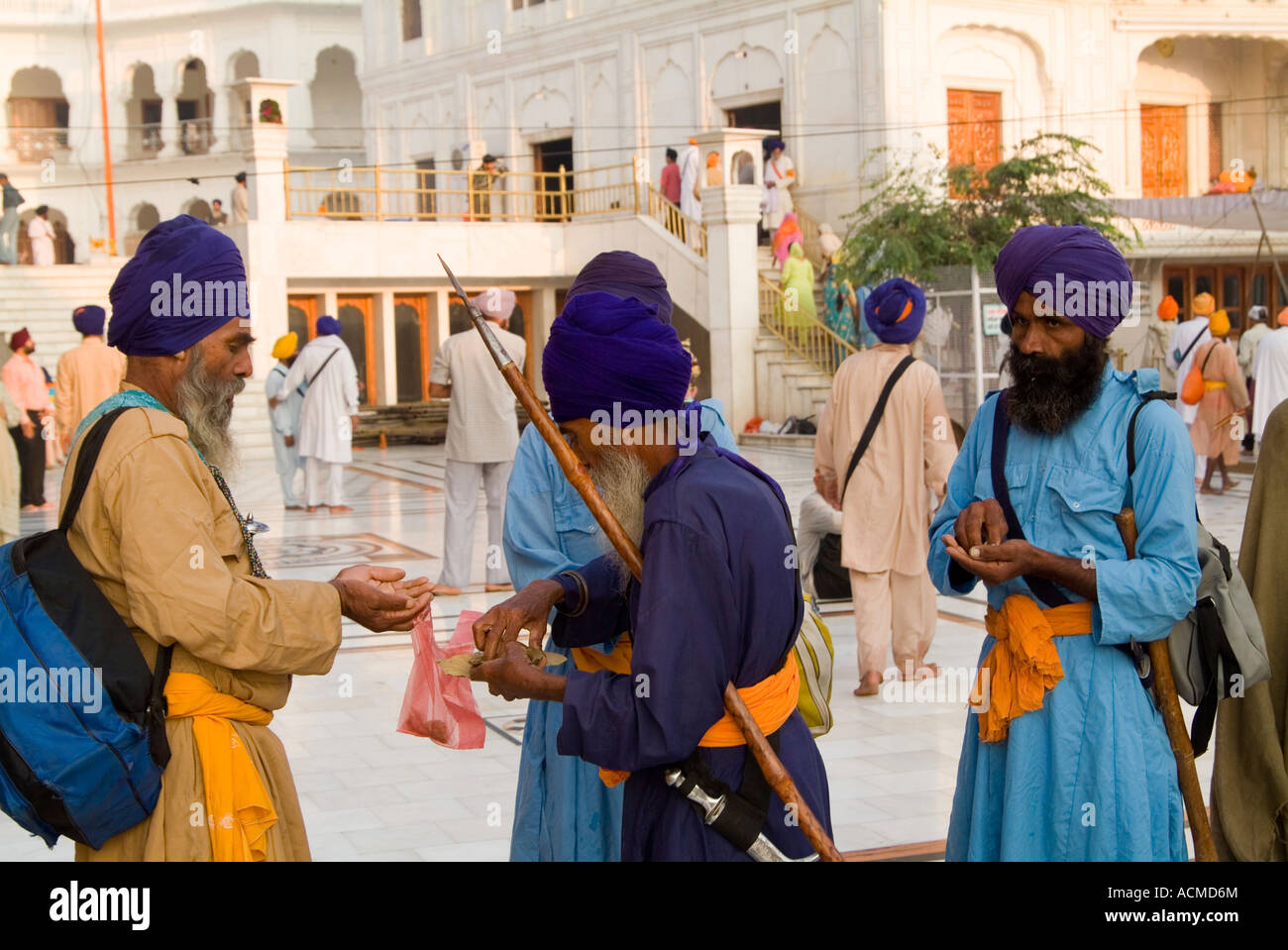 THREE SIKHS ARE SHARING PARSHAAD Stock Photo - Alamy