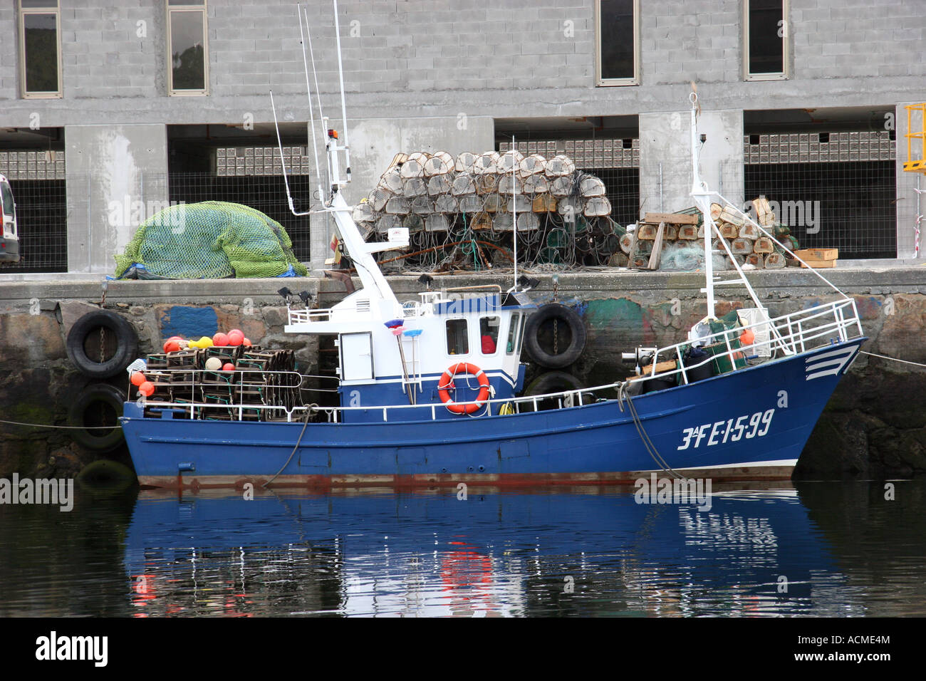 1 blue fishing boat moored hi-res stock photography and images - Alamy