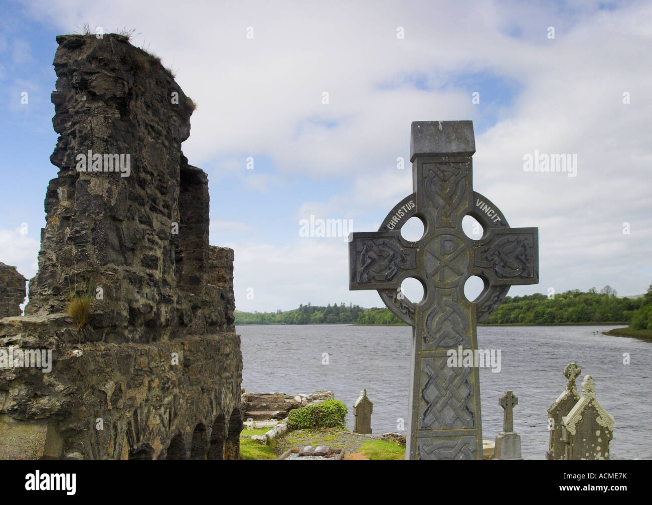 A celtic cross at Donegal Friary and cemetery In the background is ...