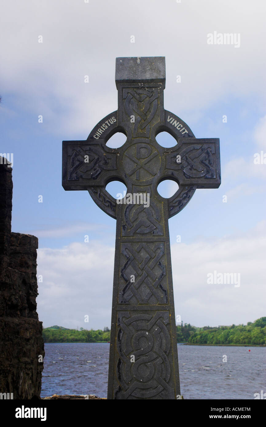 A celtic cross at Donegal Friary and cemetery In the background is ...