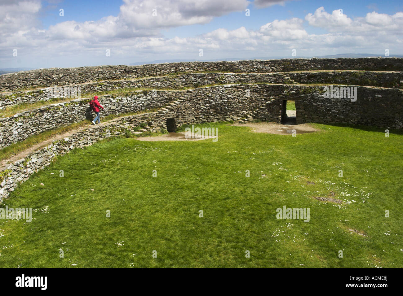 A tourist inside Grianan Ailligh an Iron Age hill fort built on a ...