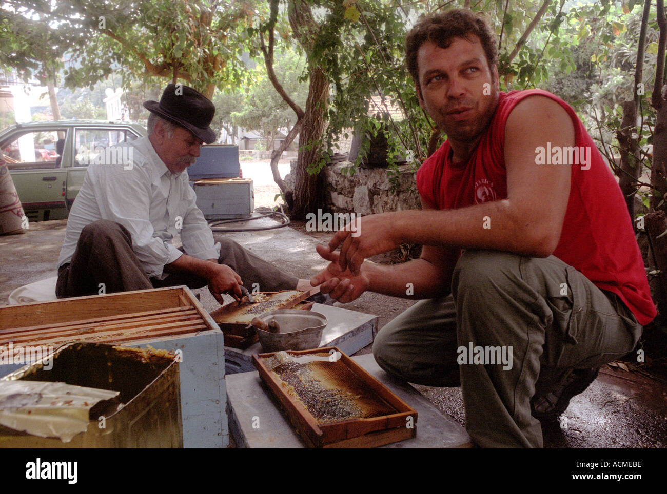 Men in small rural Turkish Village in South Western Turkey emptying and ...