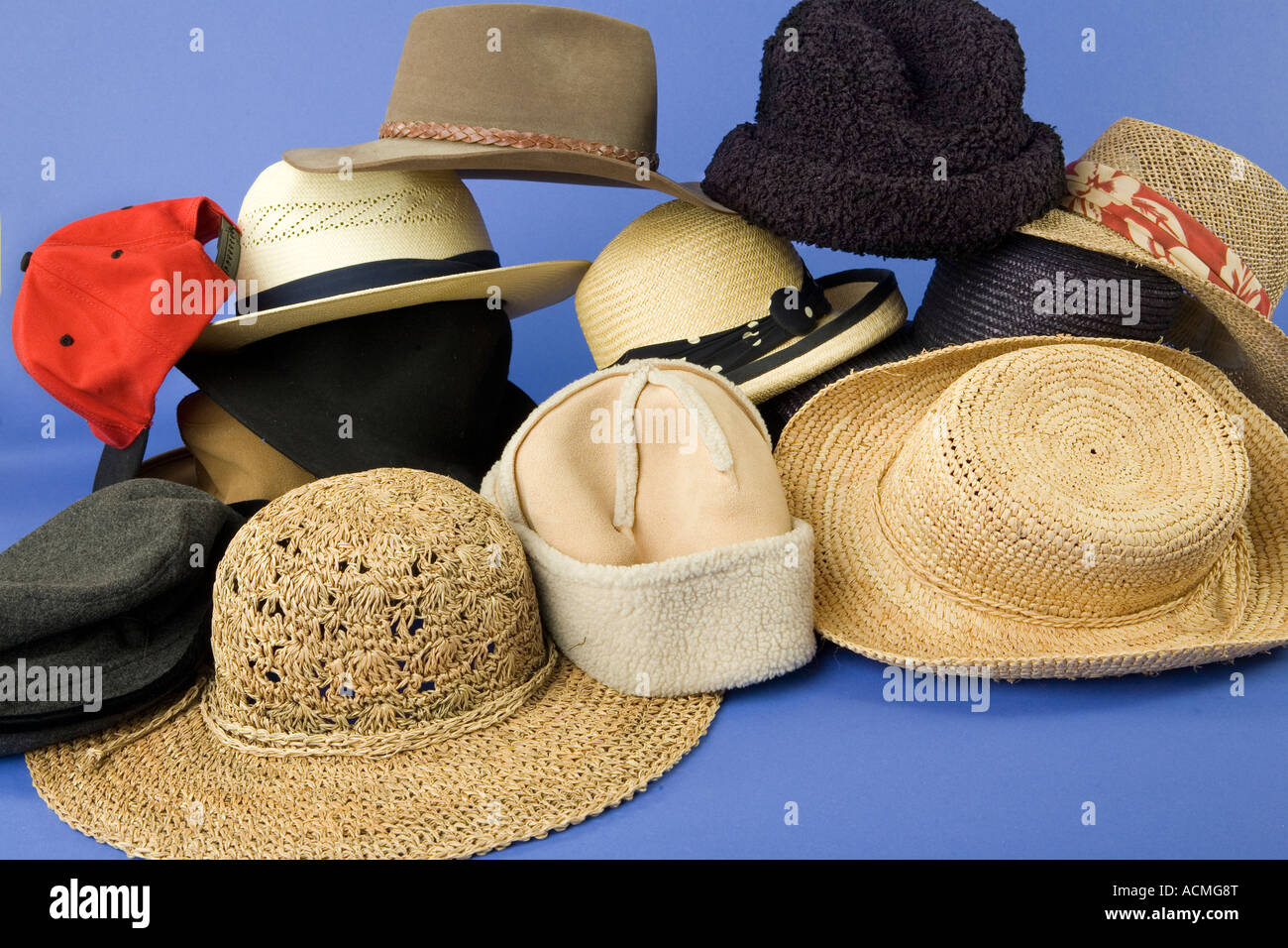 Stack of different hats on a blue background Stock Photo - Alamy