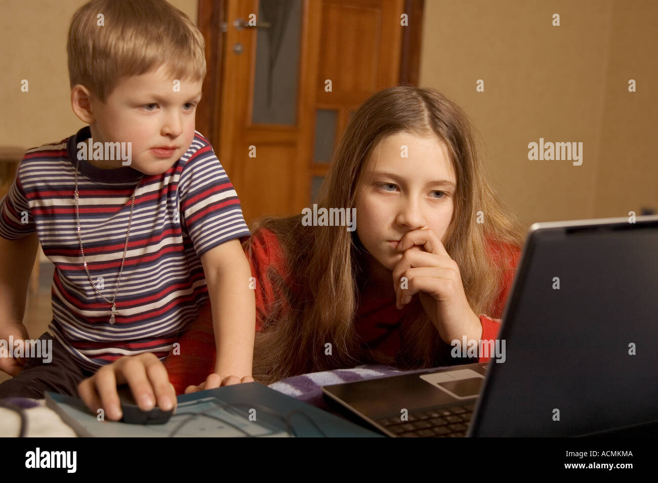 Two children working with a computer Stock Photo - Alamy
