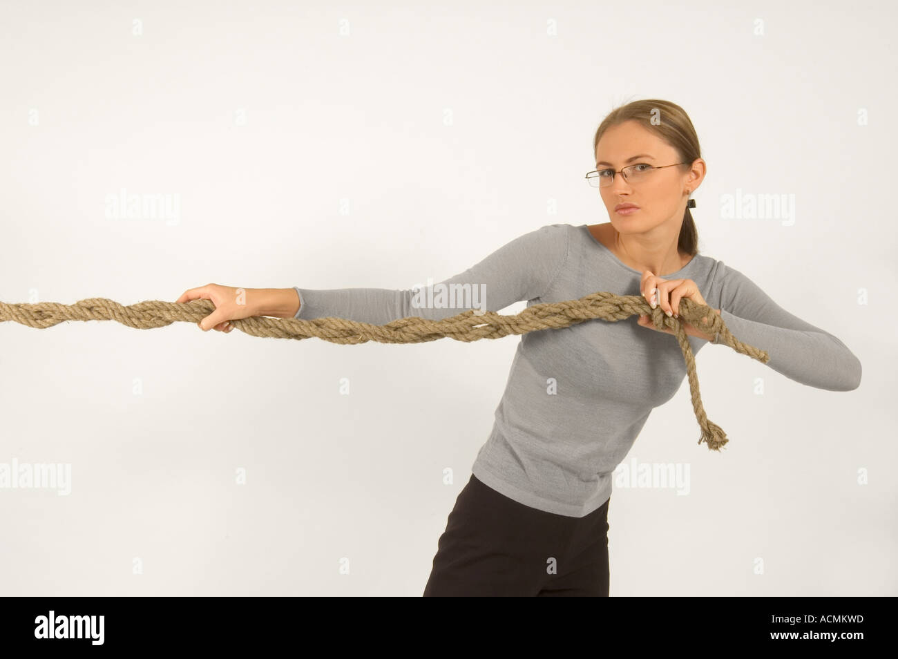 Woman pulling the rope Stock Photo - Alamy