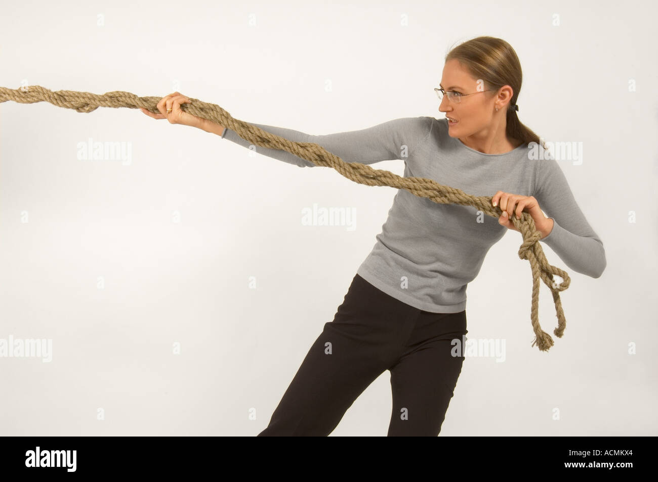 Woman pulling the rope Stock Photo - Alamy