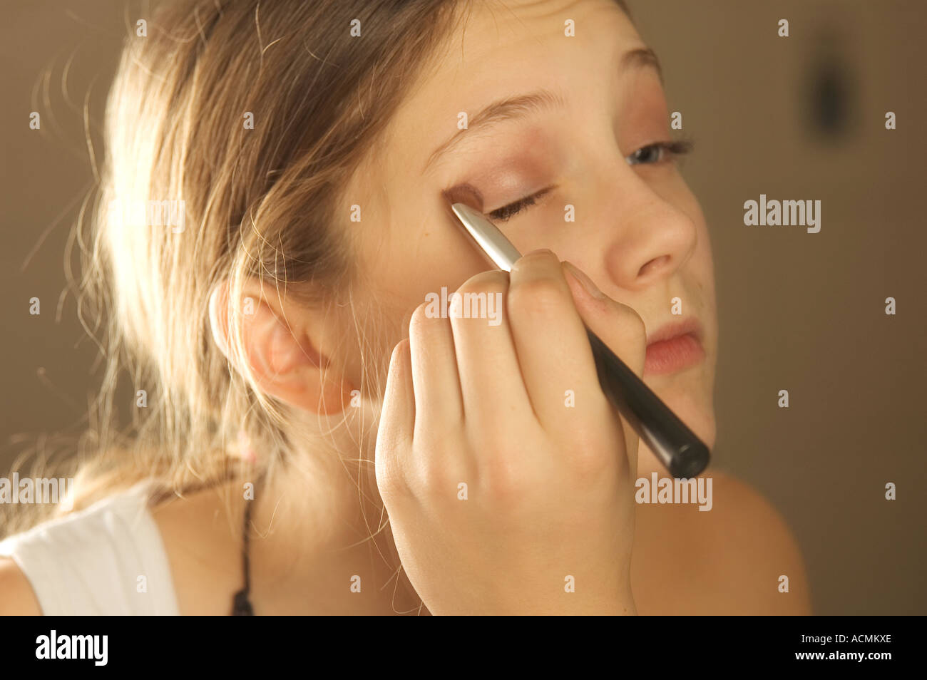 Girl using cosmetics Stock Photo - Alamy