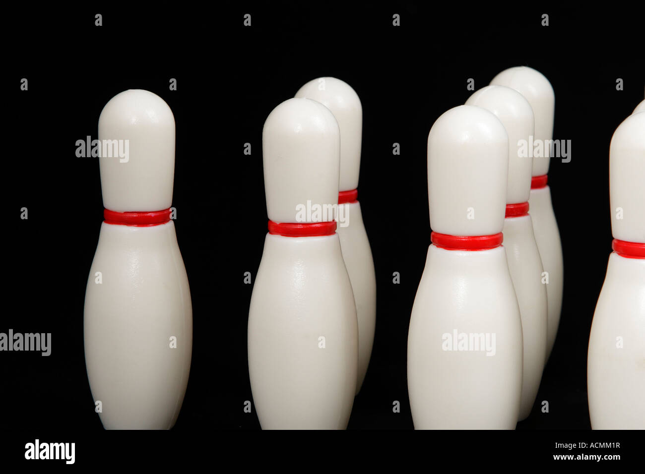 Toy plastic bowling pins on black background Stock Photo - Alamy