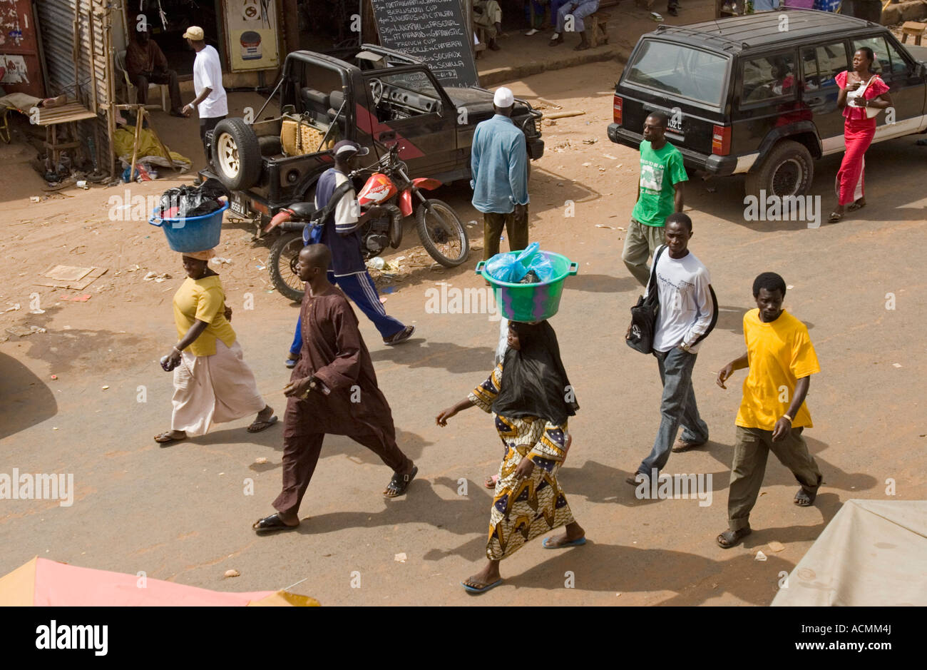 Women with large pastic basins on head visit Serekunda Market The ...