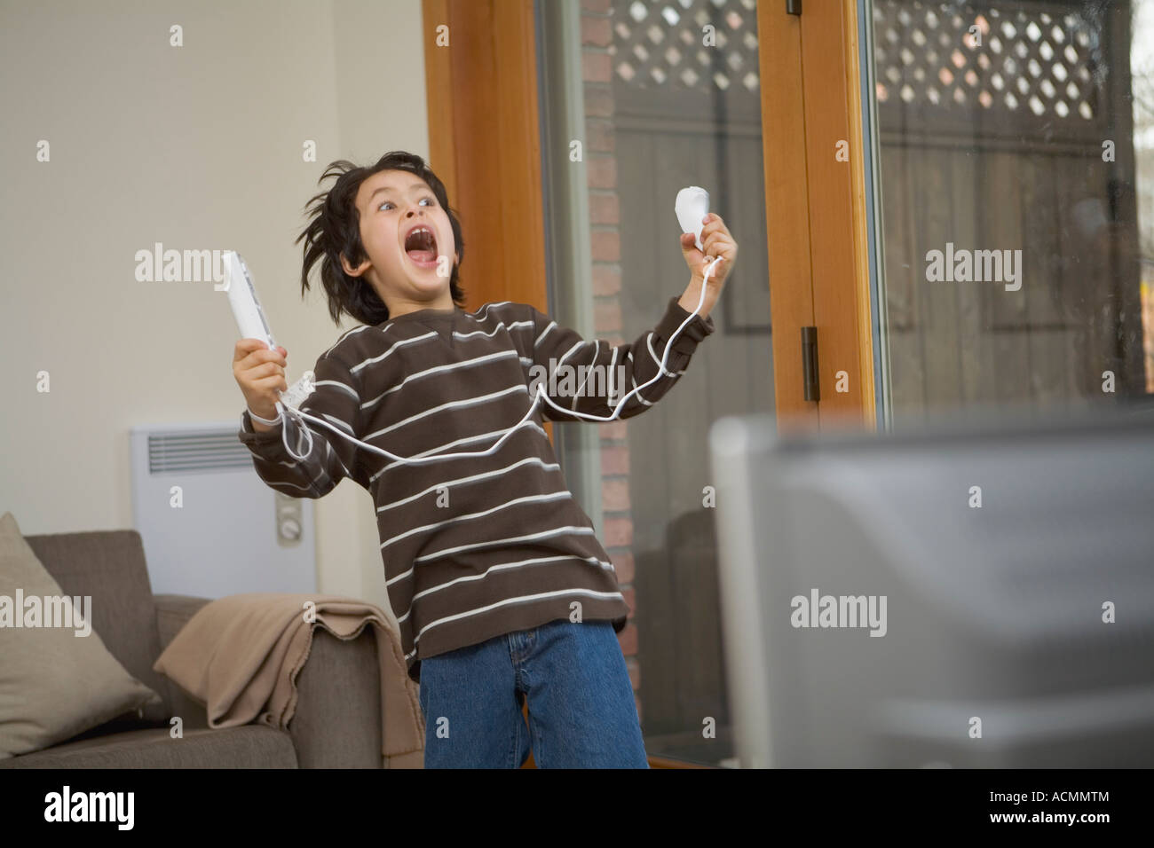 Little boy having a blast of fun, playing with the popular wireless ...