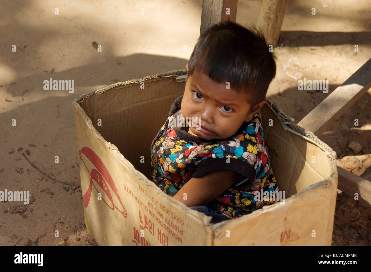 Cambodian child sitting in a box Stock Photo - Alamy