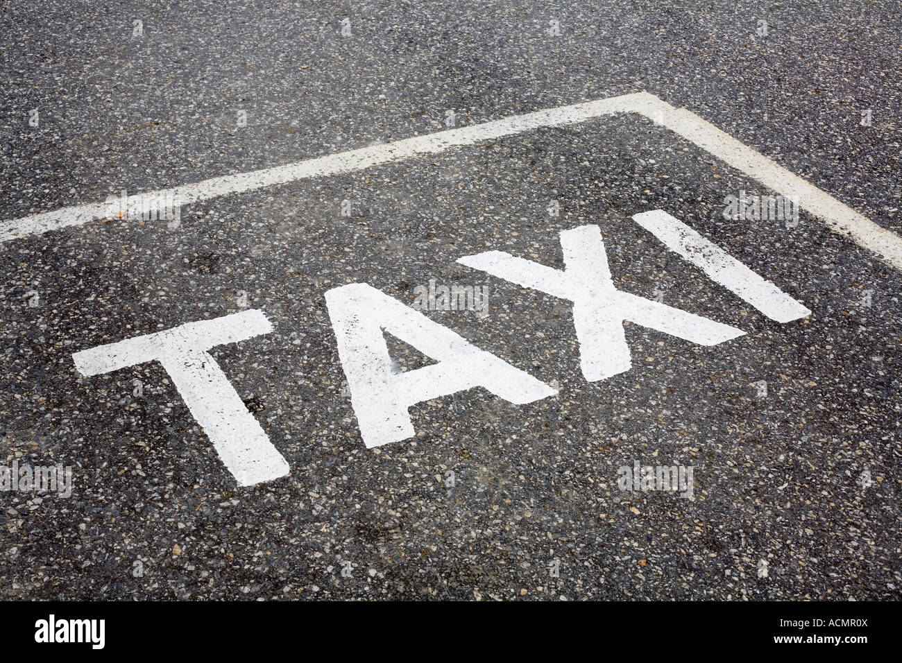 Taxi word painted on tarmac Stock Photo - Alamy