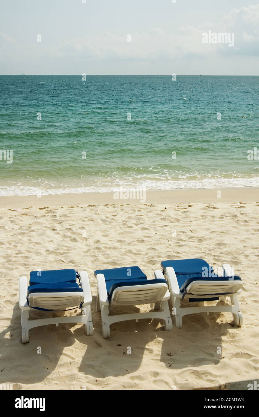 Three reclining chairs on the beach Stock Photo - Alamy
