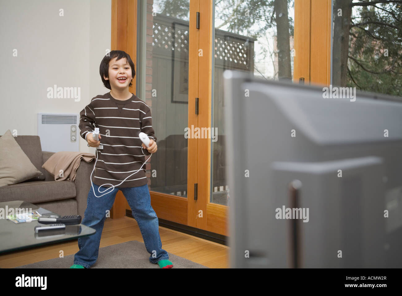 Little boy having a blast of fun, playing with the popular wireless ...