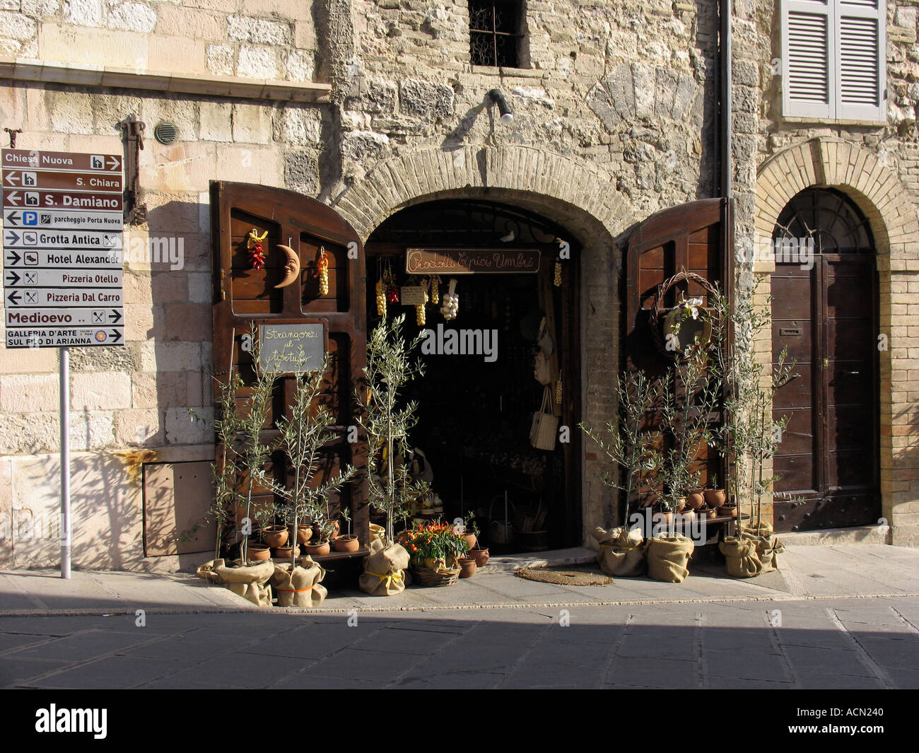 Location and attraction sign next to open doors of shop selling local ...