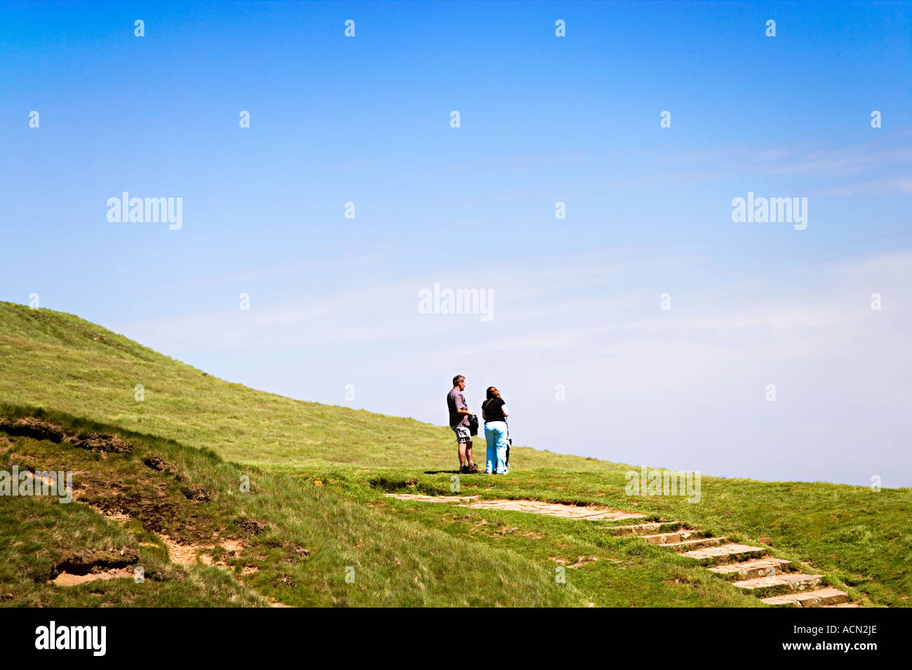 Two Adults Man Women Hiking Walking Up "Mam Tor" Mountain Summit ...