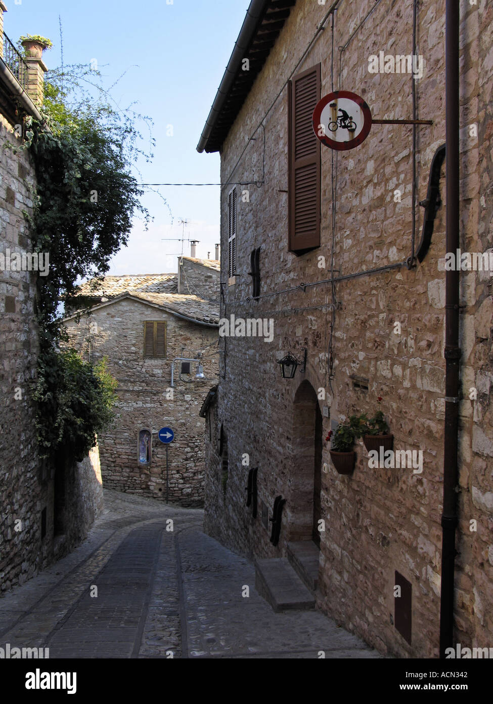 Narrow stone path leading downhill between houses in hilltown village ...
