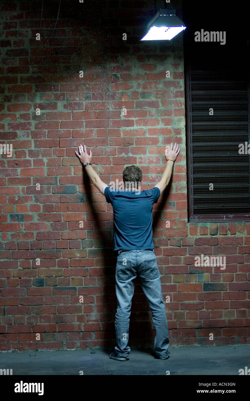 young male man teenager punching punch hit hitting brick wall portrait ...