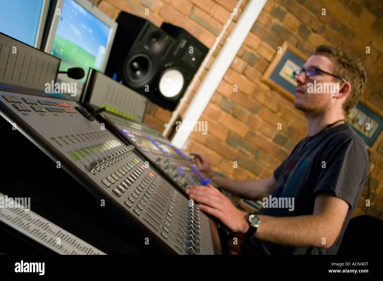 young man mixing at sound desk console mixer in recording studio Stock ...