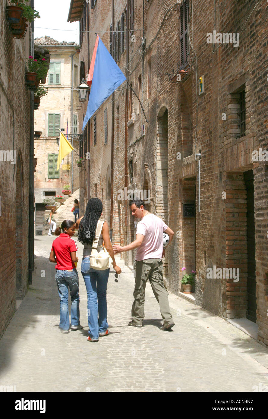 visitors strolling the ancient passageways of sarnano in Le Marche ...