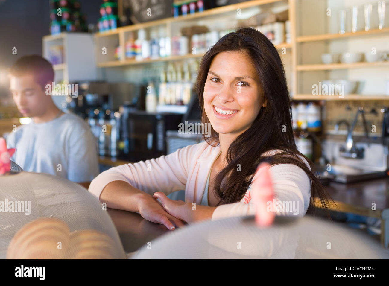 young woman and man behind counter in cafe Stock Photo - Alamy