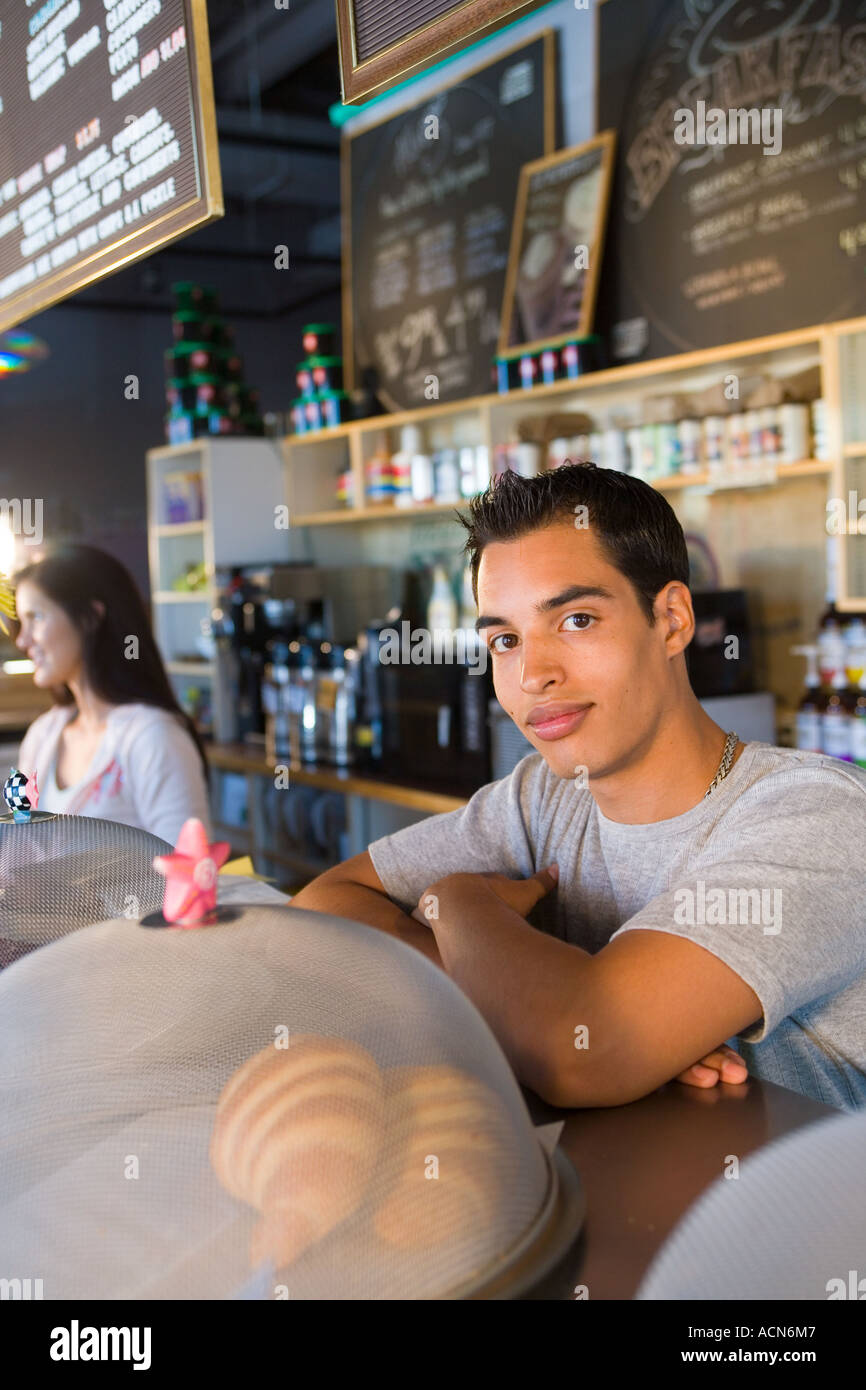 young man behind counter in cafe Stock Photo - Alamy