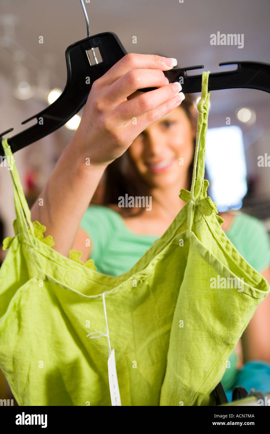 young woman looking at clothes in womans clothing store Stock Photo - Alamy
