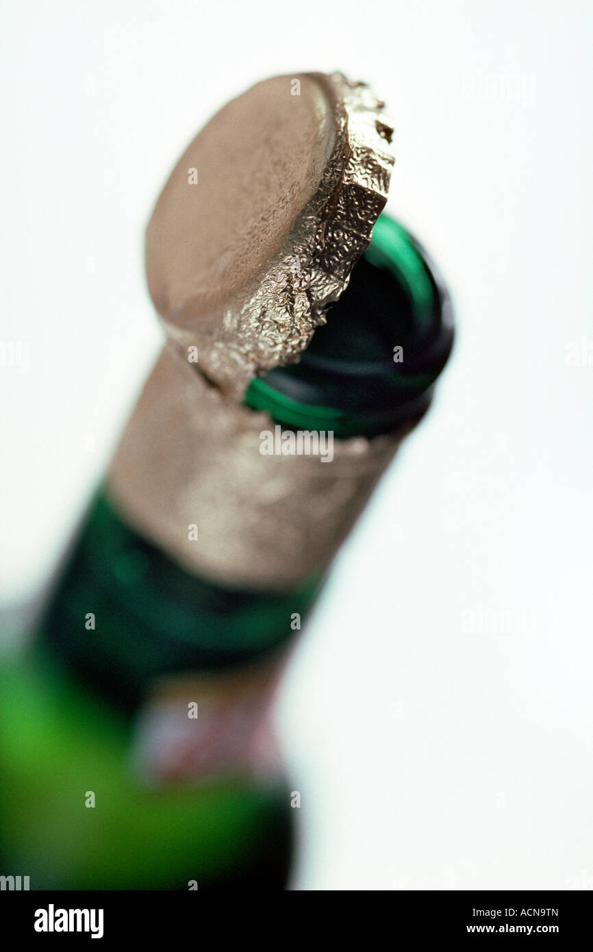Close-up of a beer bottle neck with the cap just opened Stock Photo - Alamy